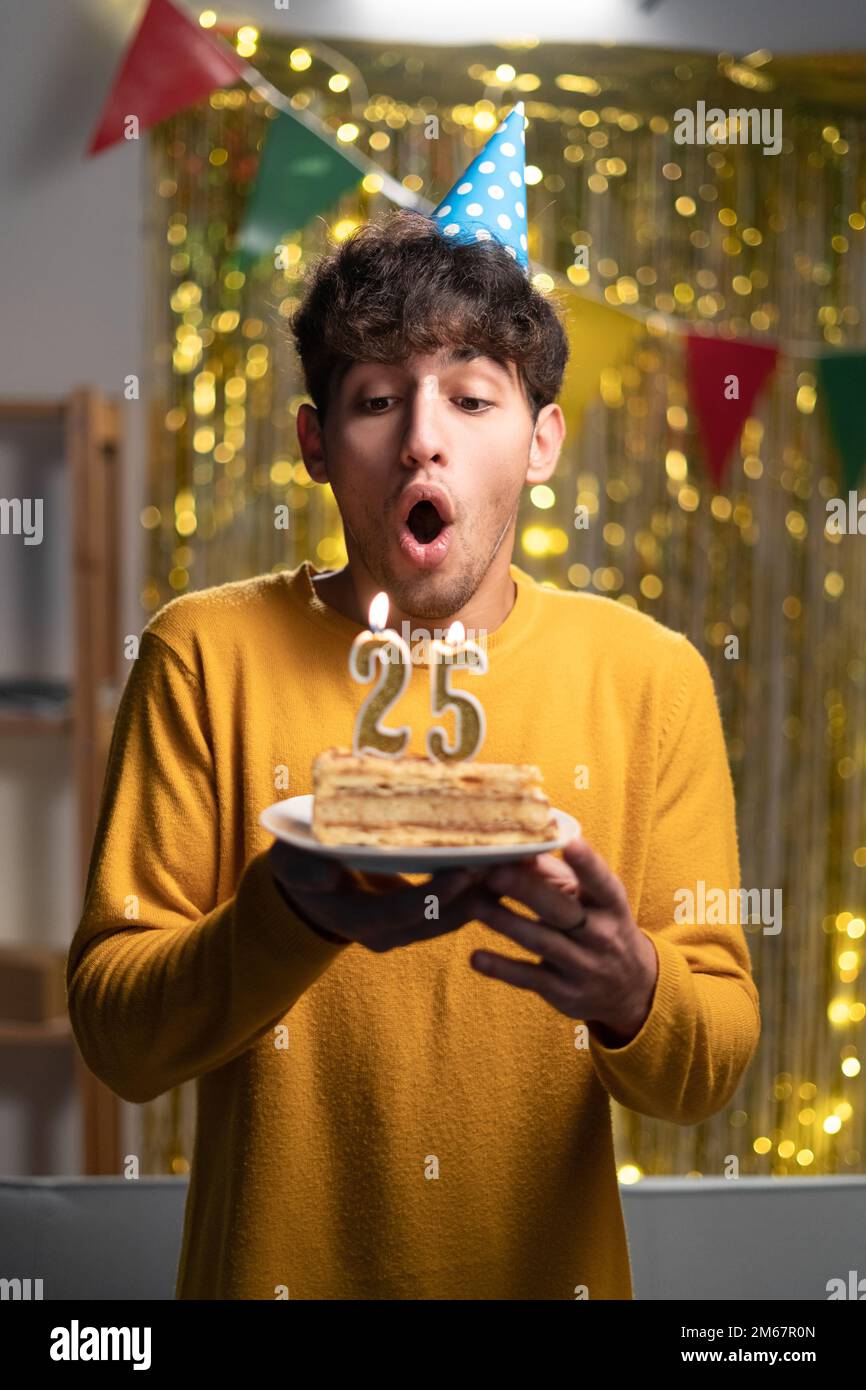 Holidays and celebration. Excited young man celebrating 25th birthday ...