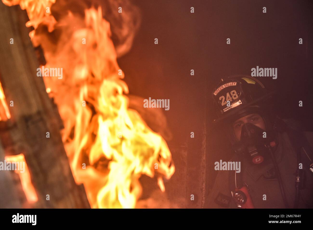A local firefighter from the Green Valley Fire District fights a ...