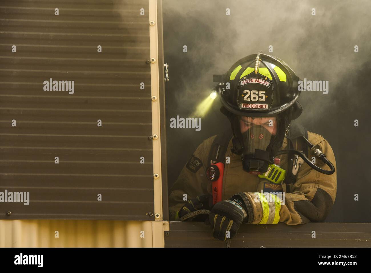 A local firefighter from the Green Valley Fire District clears a ...