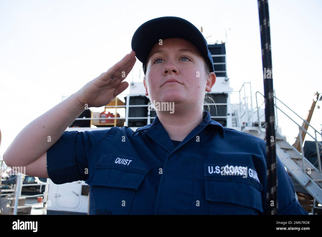Coast Guard Seaman Michela Quist salutes during morning colors aboard ...