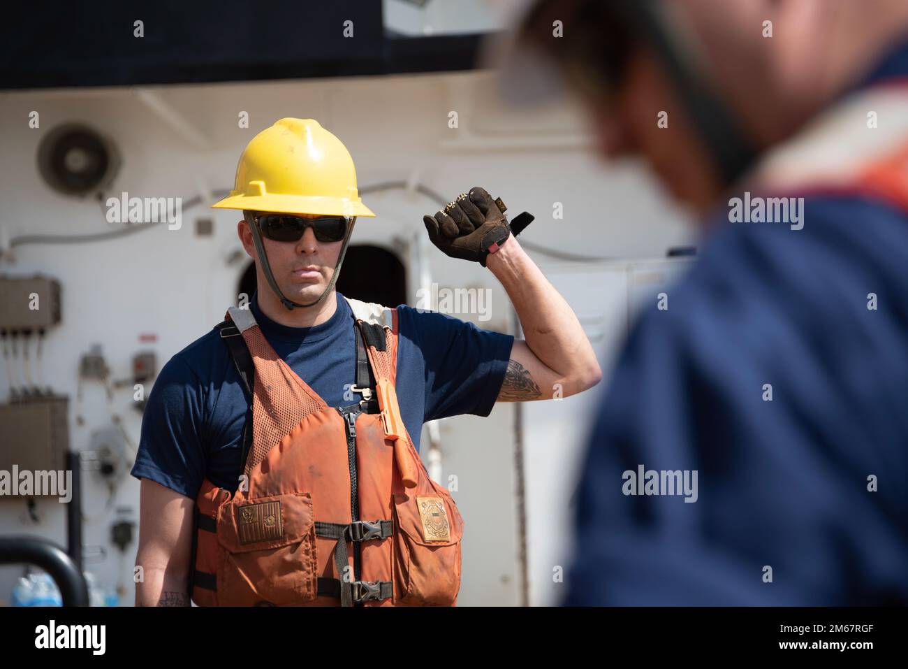 Coast Guard crew members work aboard the U.S. Coast Guard Cutter ...
