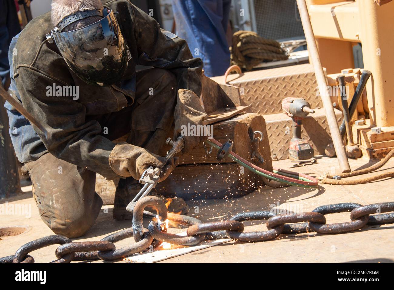 Crew members on the U.S. Coast Guard Cutter William Tate work aboard ...