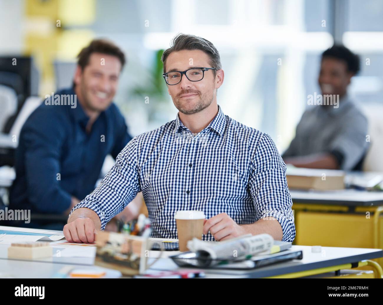 They always follow my lead. Portrait of an office worker sitting at his ...