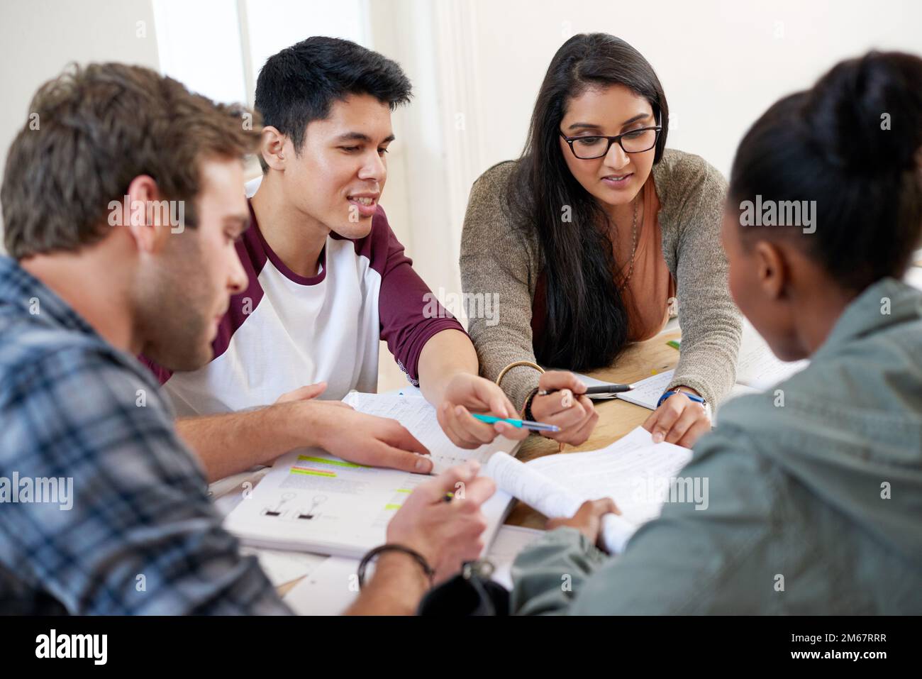 Working on their group assignment. a group of university students in a ... Working on their group assignment. a group of university students in a ...