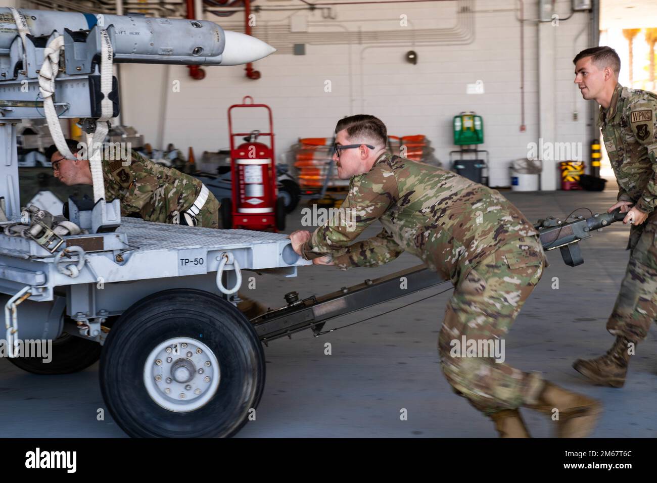 Airmen assigned to the 15th Aircraft Maintenance Squadron weapons load ...