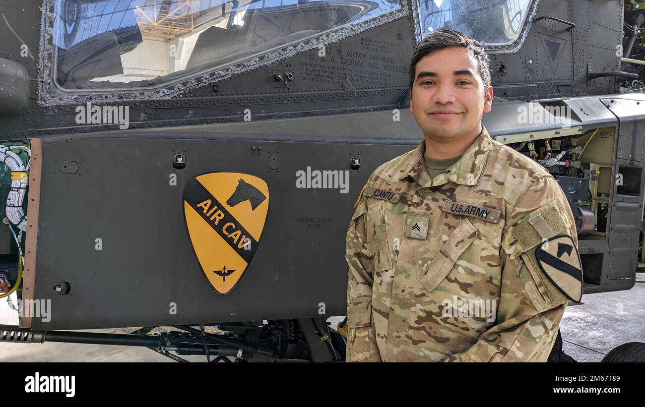 Cpl. Oscar Cantu poses next to an AH-64 Apache aircraft at Storck ...
