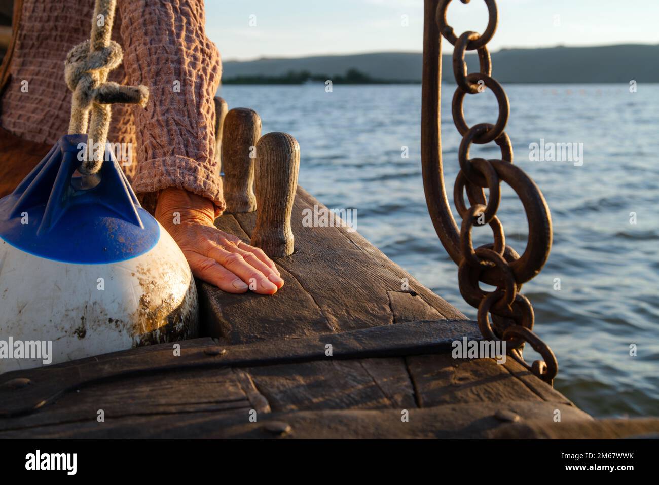 Close up of wrinkled sailor hand, sailing into the sunset. Experienced ...