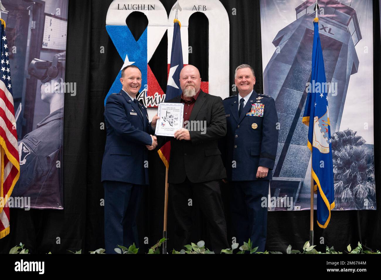 Mr. Gilbert Wheeler, member of the 47th Medical Group, accepts an award ...