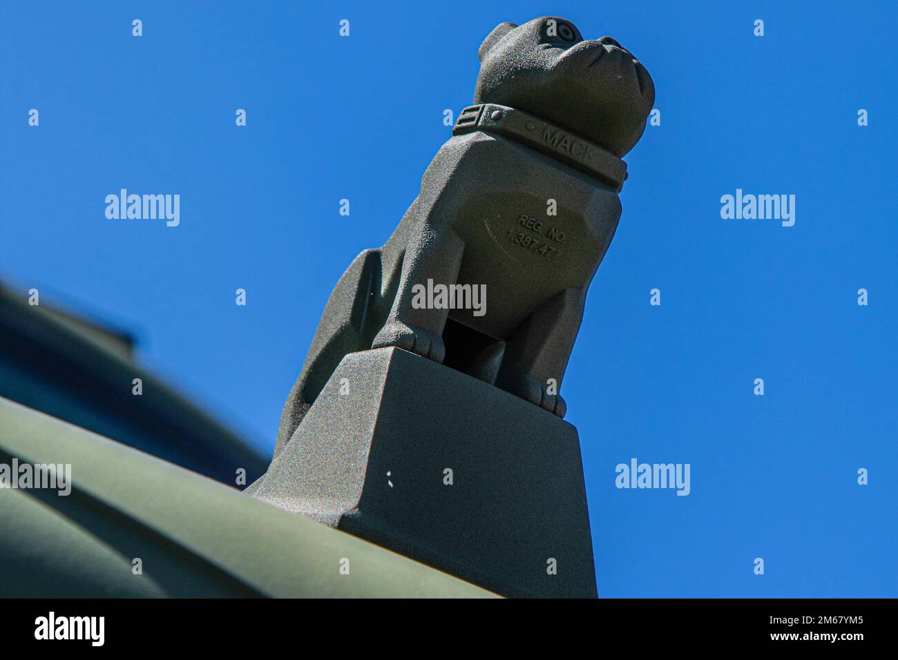 The Mack Defense bulldog mascot stands proud on top of the heavy dump ...