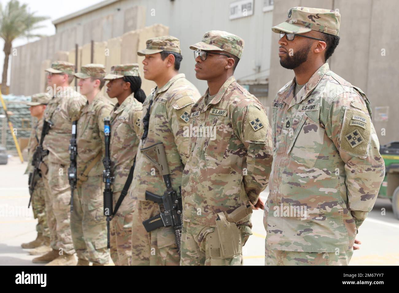 U.S. Soldiers assigned to Task Force Pioneer stand at the position of ...