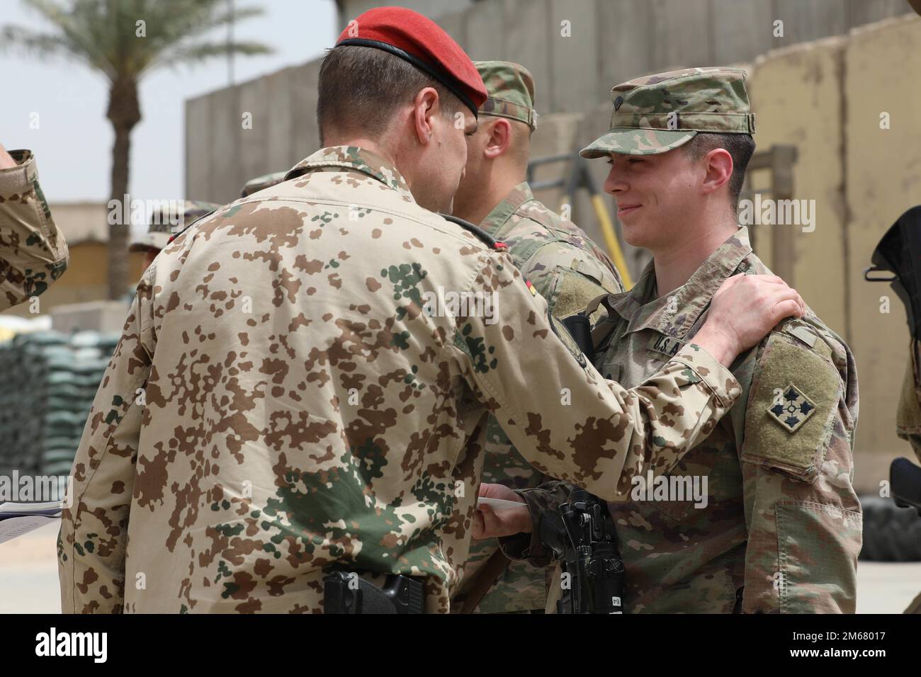 A U.S. Soldier assigned to Task Force Pioneer accepts a certificate of ...