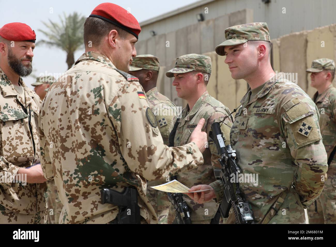 A U.S. Soldier assigned to Task Force Pioneer accepts a certificate of ...