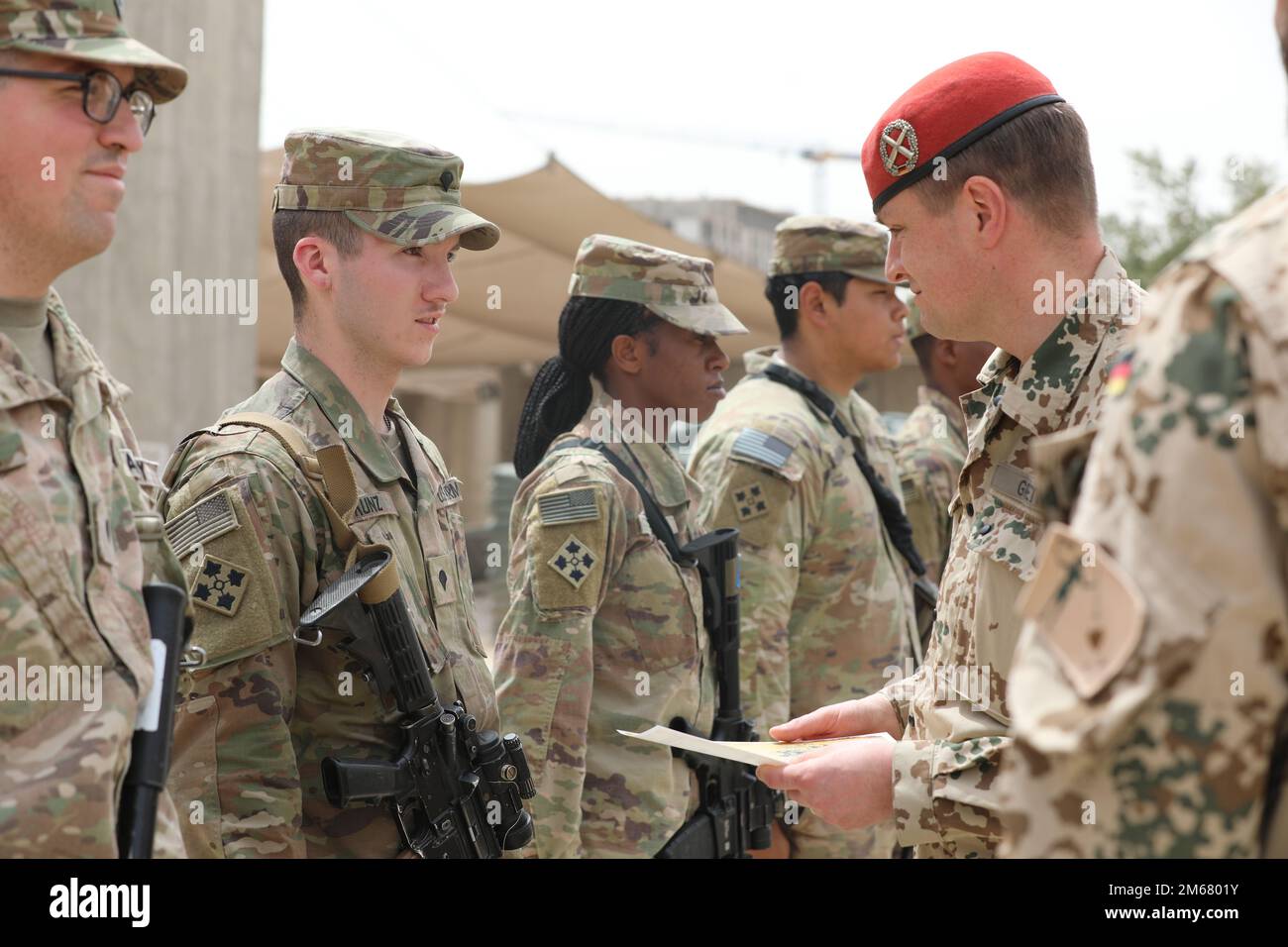 A U.S. Soldier assigned to Task Force Pioneer accepts a certificate of ...