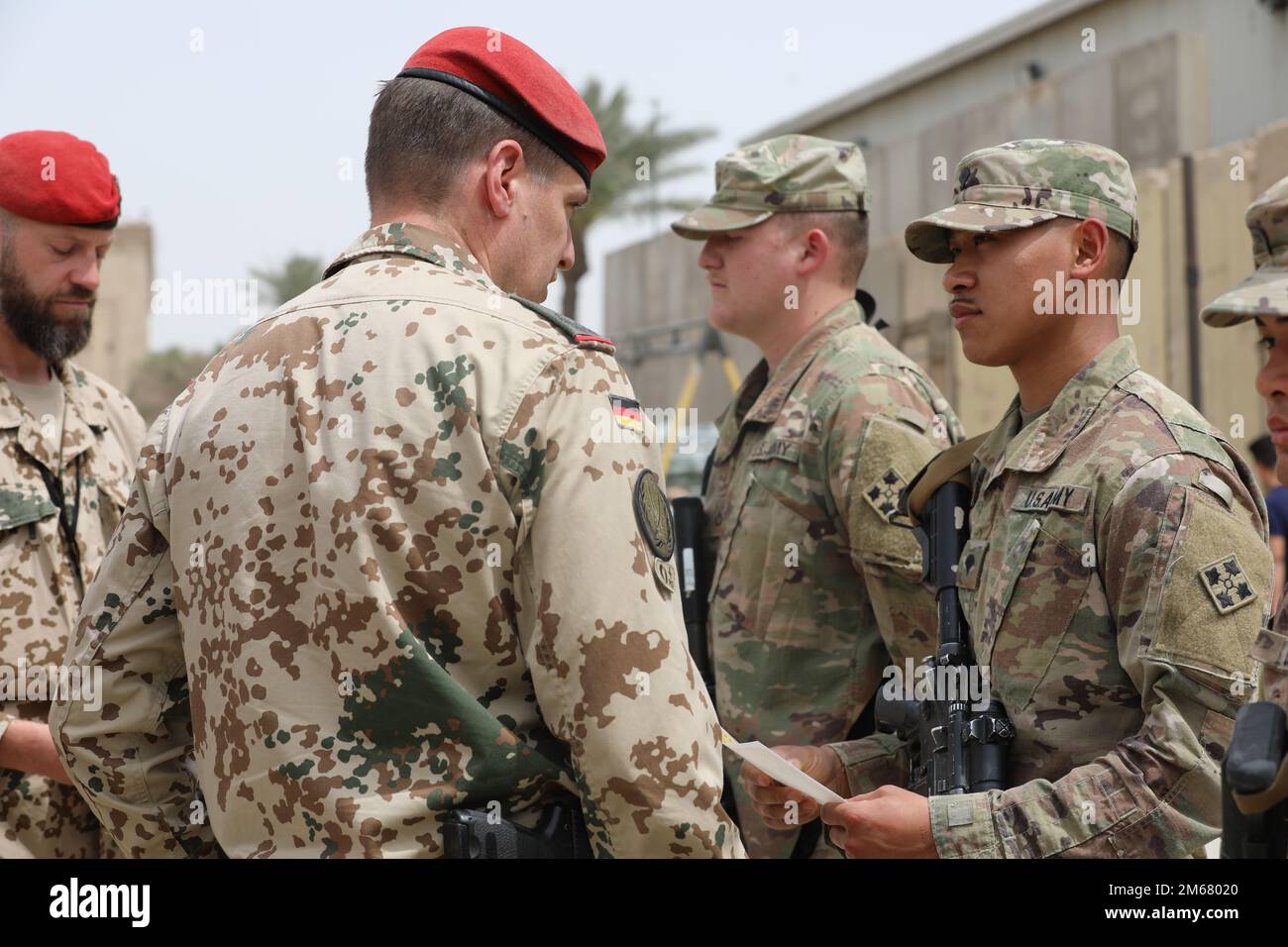 A U.S. Soldier assigned to Task Force Pioneer accepts a certificate of ...