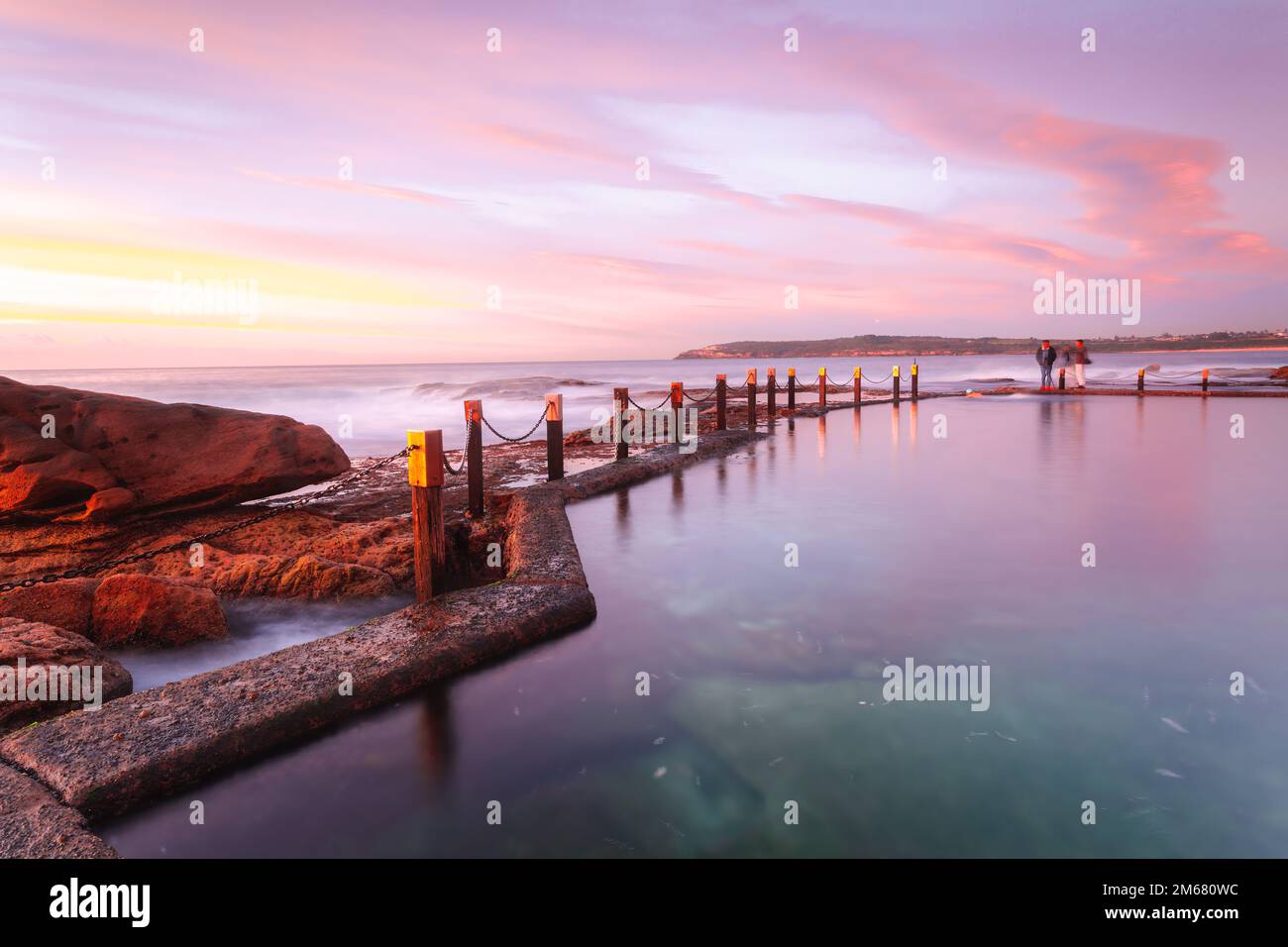 Serene pastel colours of early dawn morning light at Mahon ocean rock ...