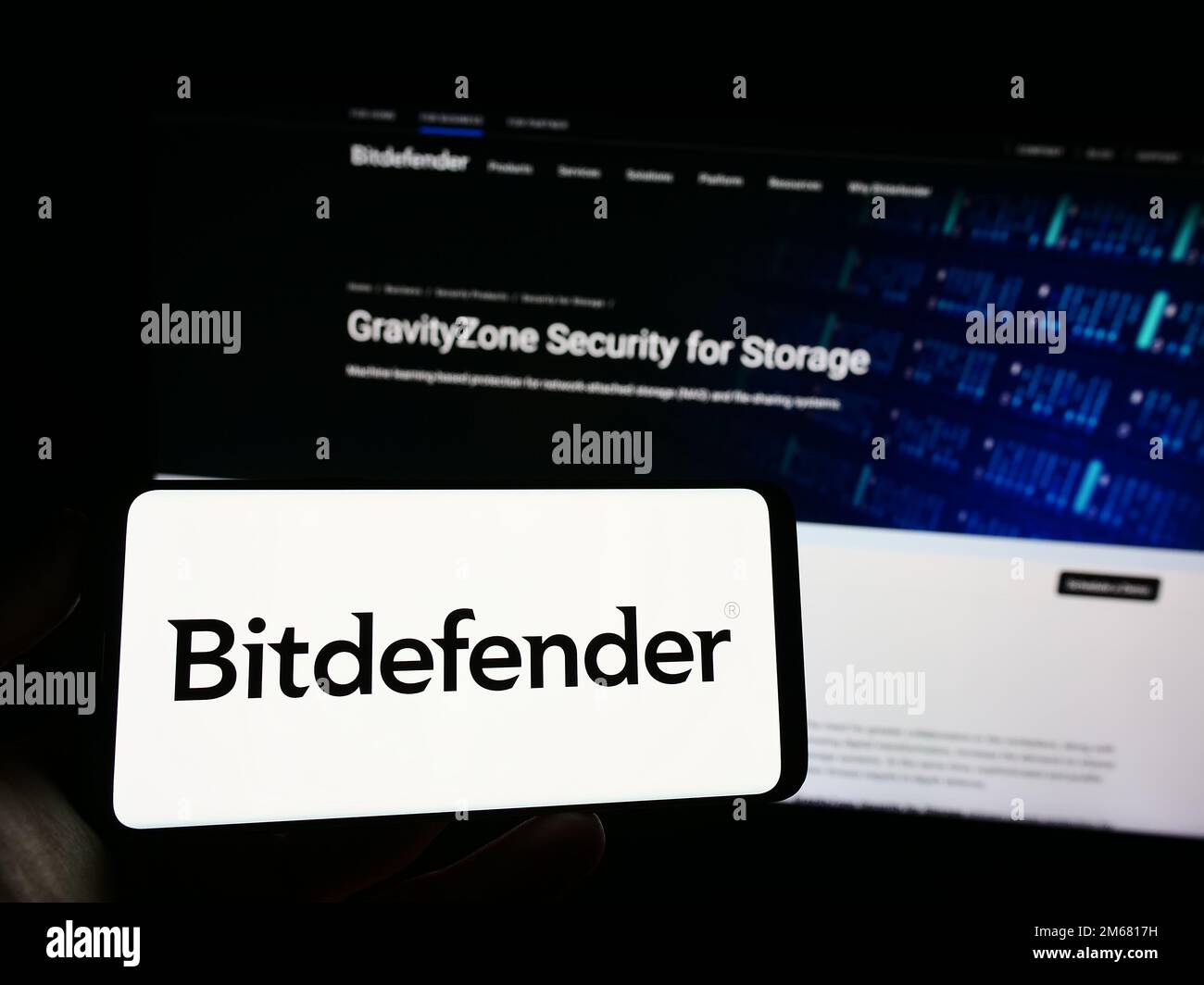 Person holding mobile phone with logo of Romanian cybersecurity company ...