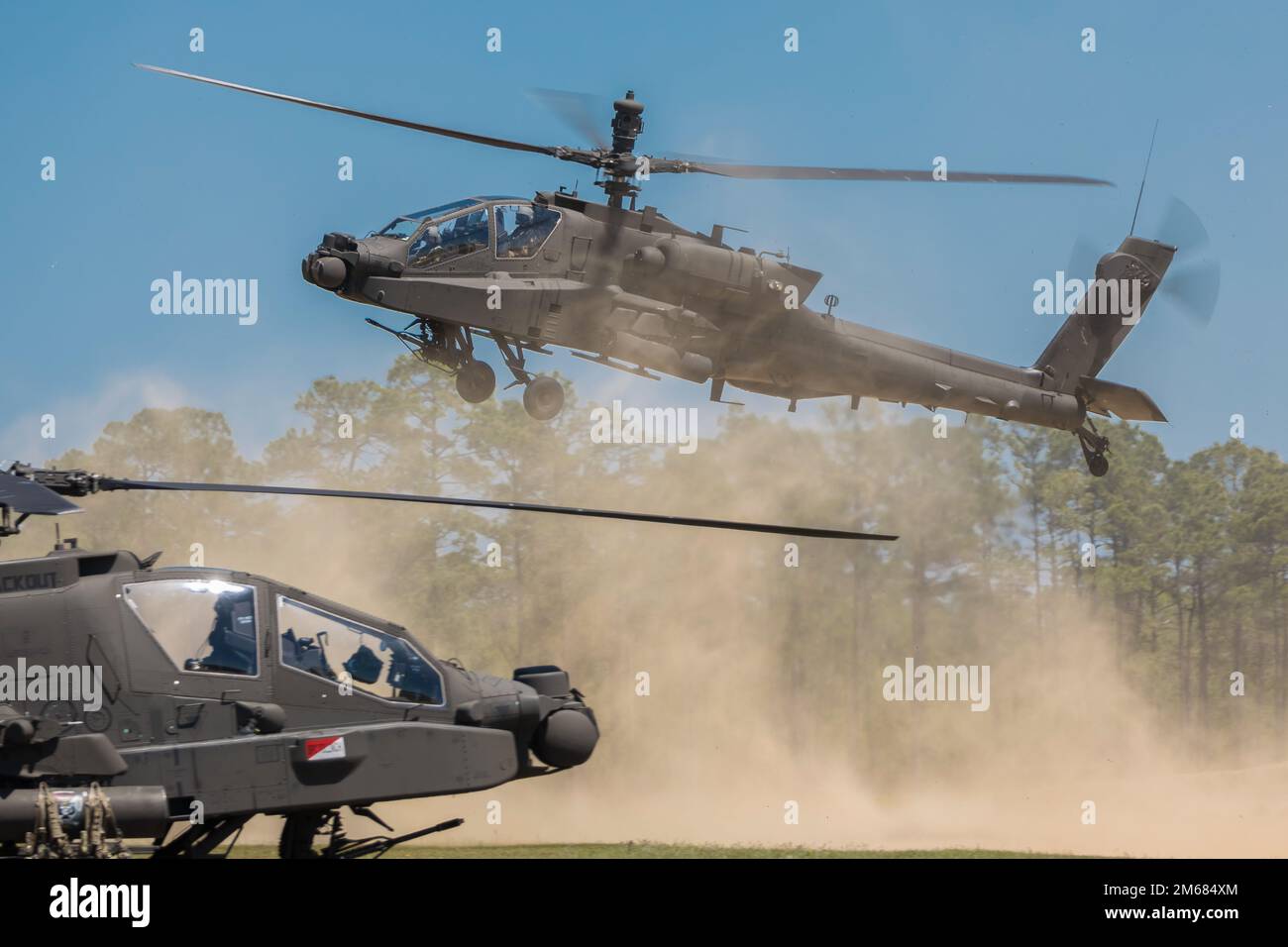 An AH-64E Apache helicopter takes flight during an aerial gunnery ...