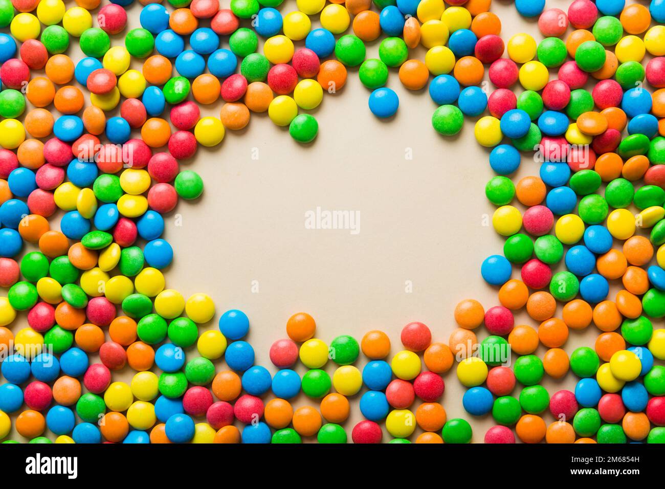 Mixed collection of colorful candy, on colored background. Flat lay ...