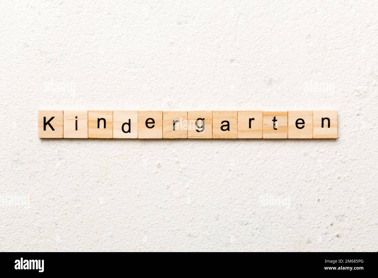 kindergarten word written on wood block. kindergarten text on table ...