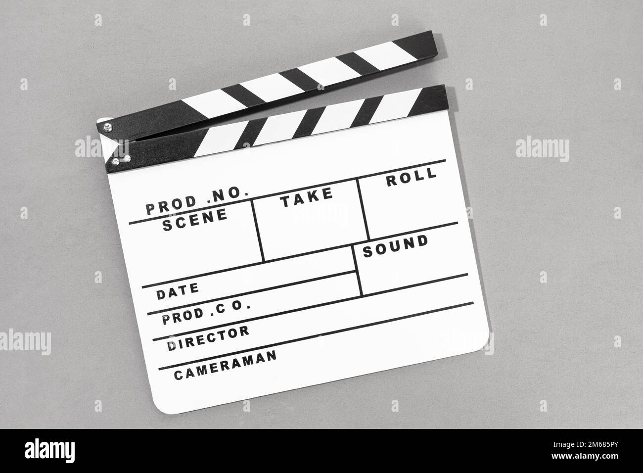 Top view of a White Movie clapper board on gray background. Template ...
