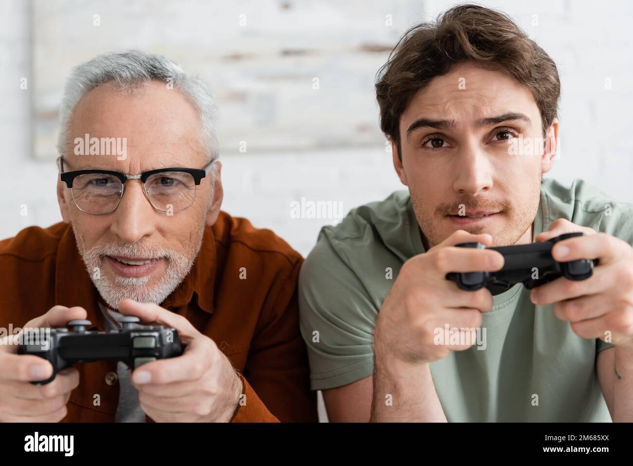 KYIV, UKRAINE - MAY 11, 2022: tensed guy with joystick playing video ...