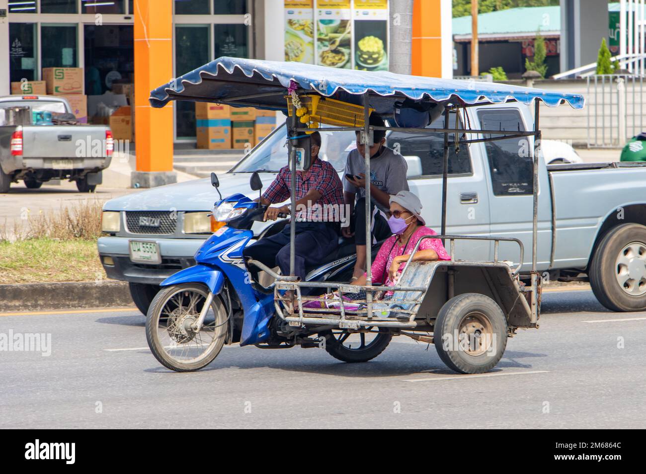 RATCHABURI, THAILAND, NOV 16 2022, People ride a motorcycle with a ...
