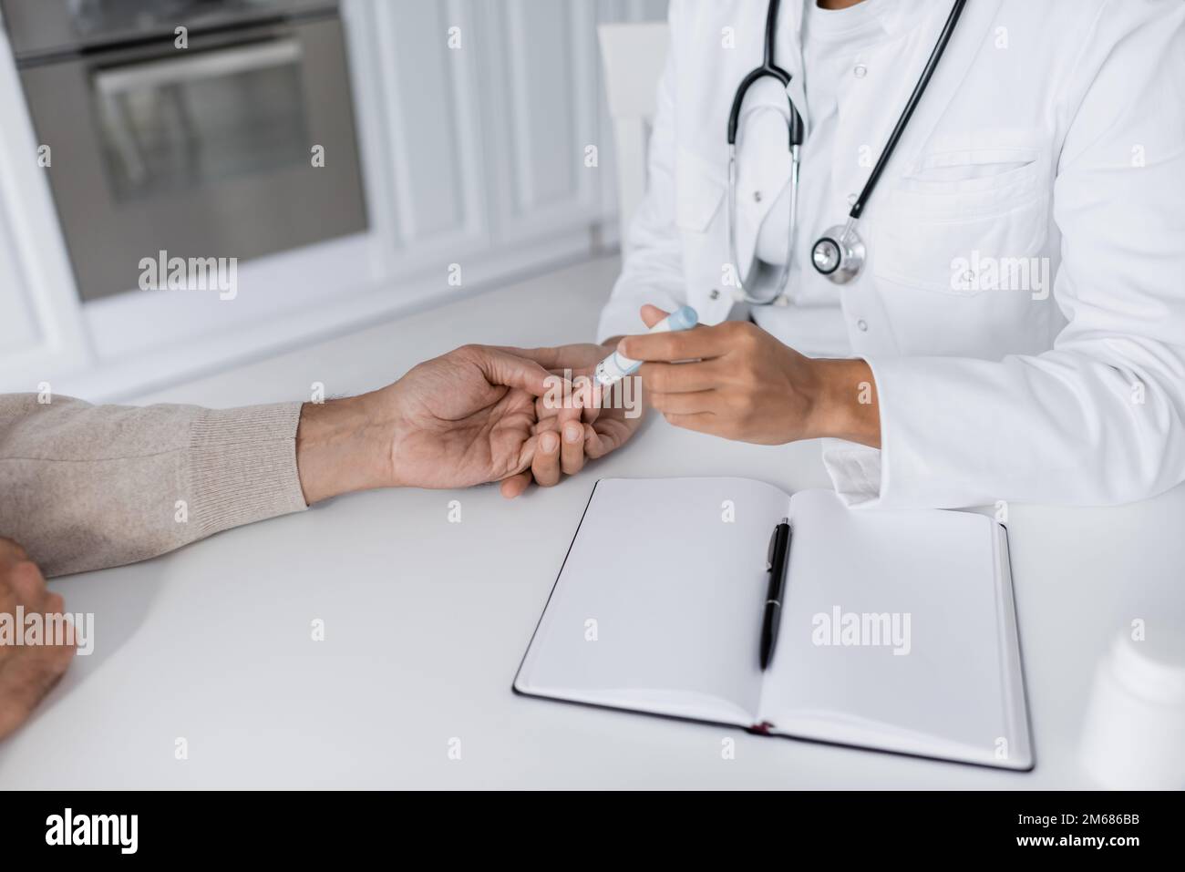 cropped view of african american doctor taking blood sample of middle ...