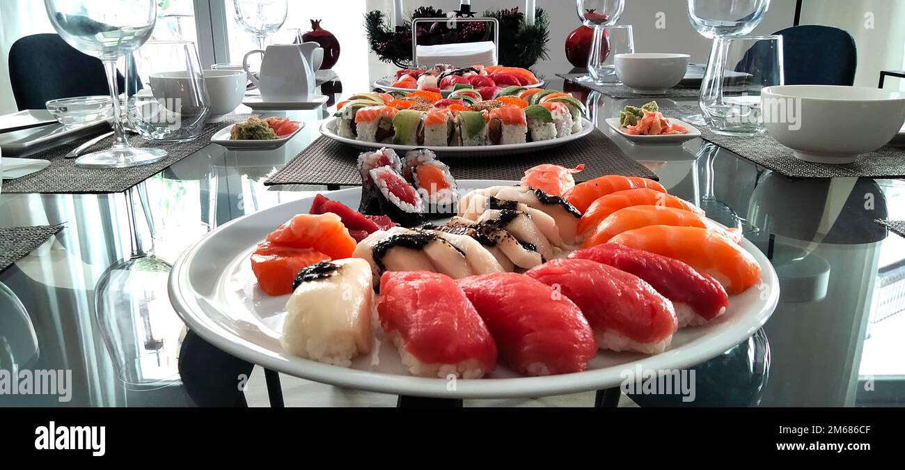 Glass table setting for celebration. Japanese sushi food. Maki, nigiri ...