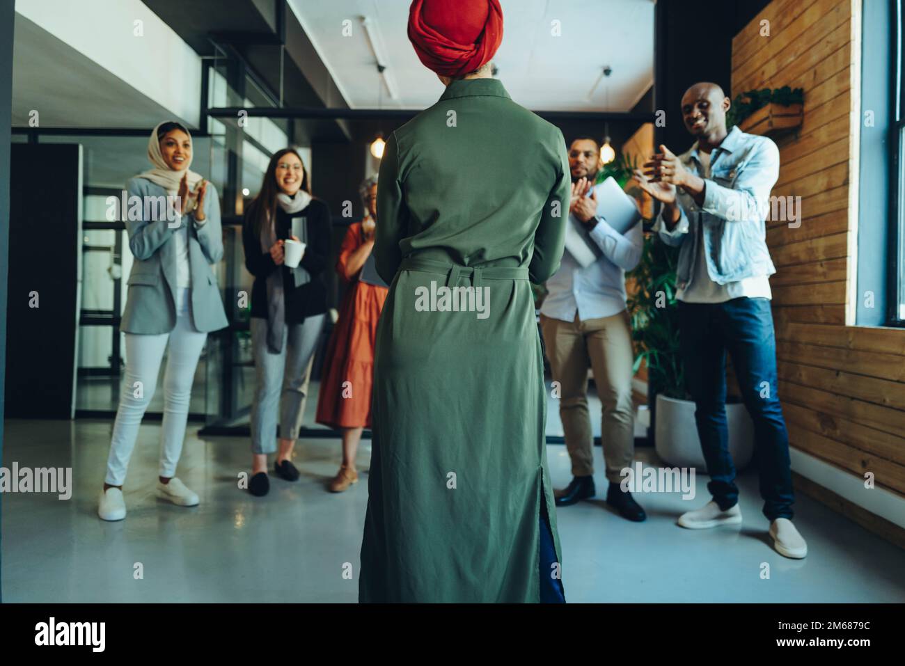 Successful team leader receiving an applause from her business ...