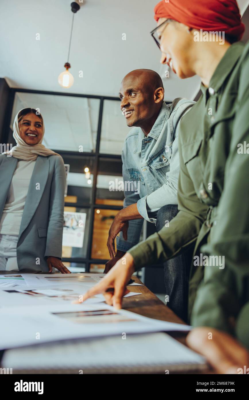 Cheerful interior designers working with colour palettes in a modern ...