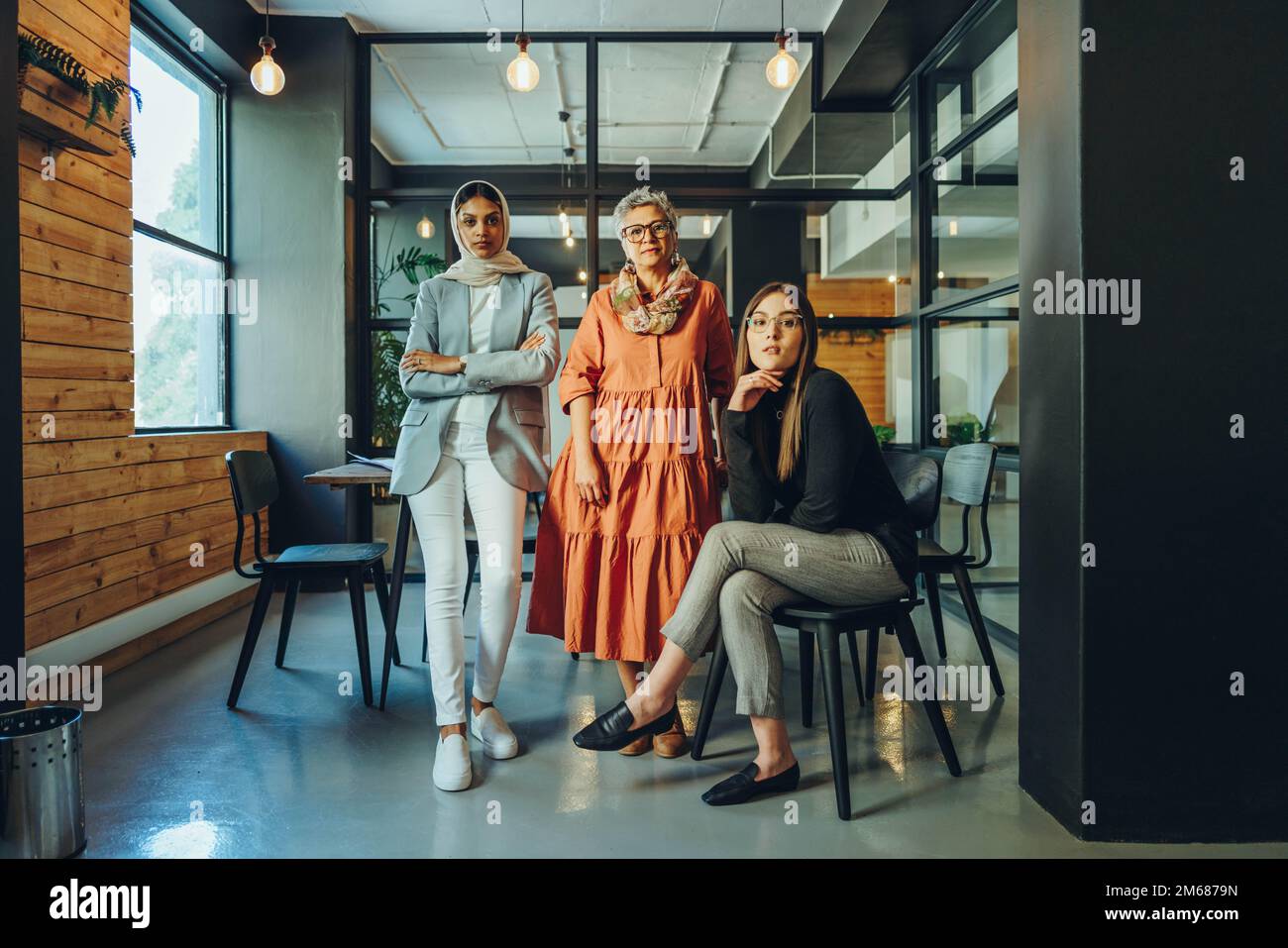 Team of multicultural businesswomen looking at the camera in an office ...