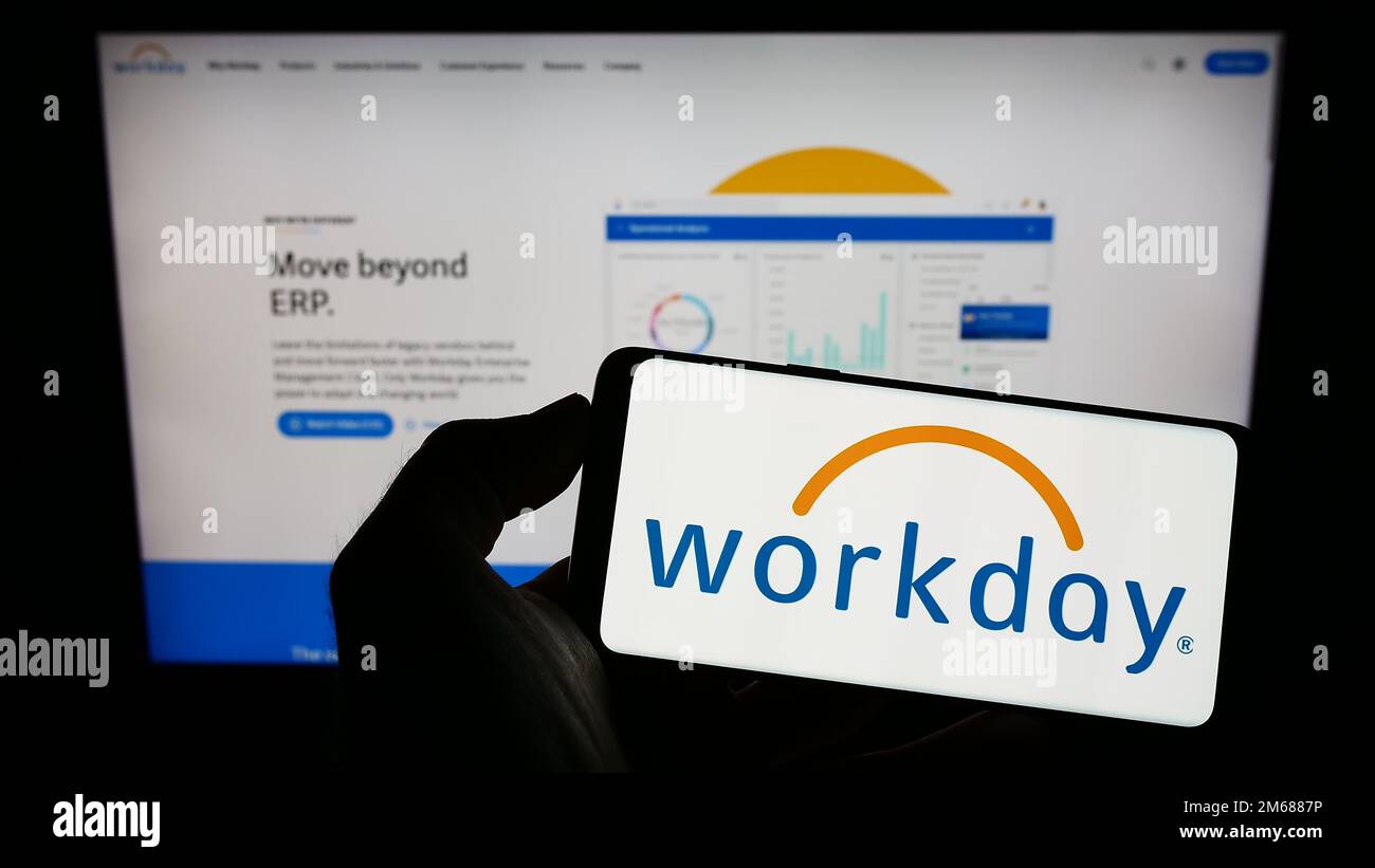 Person holding mobile phone with logo of American software company ...