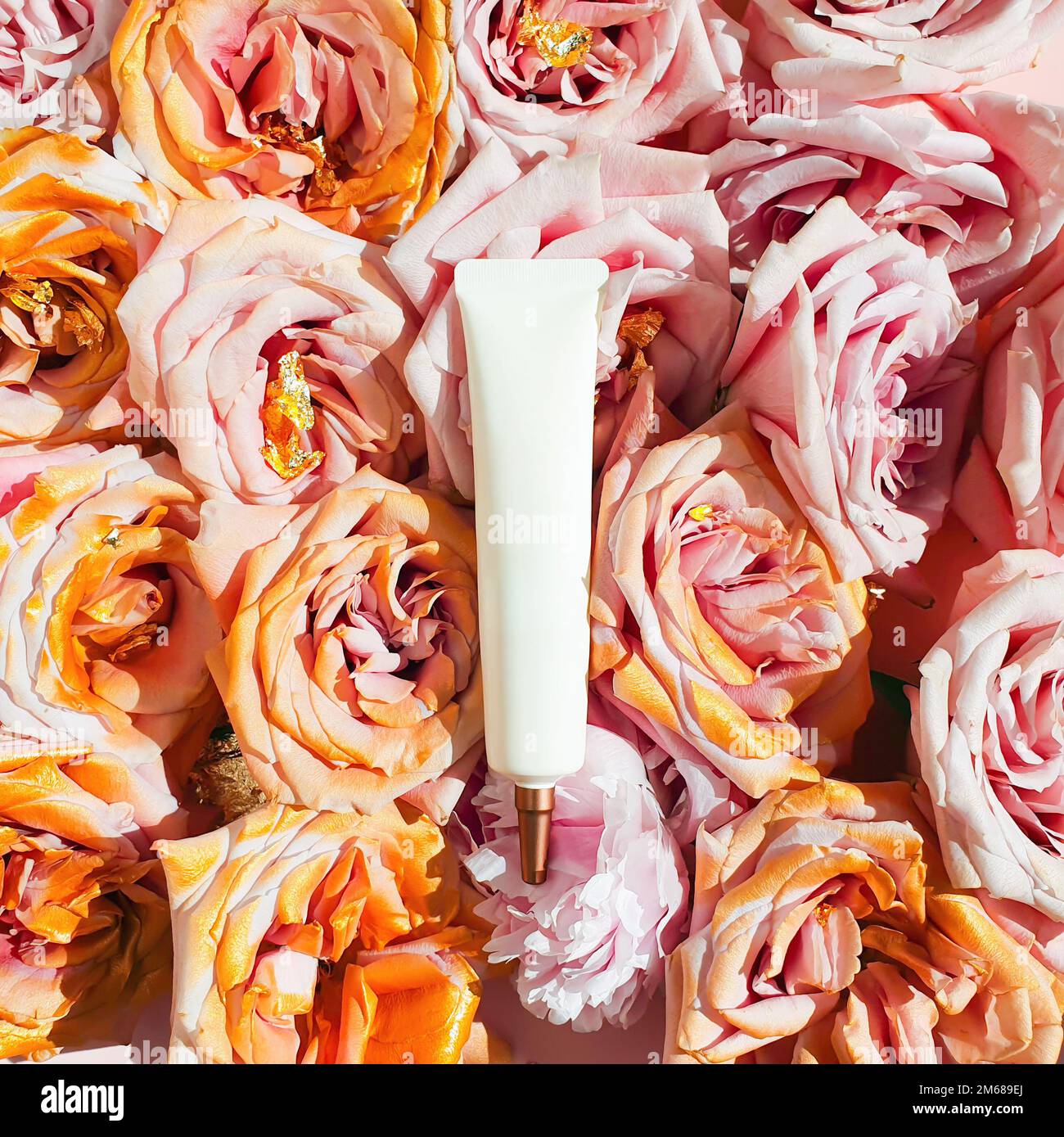 Mock-up of ivory squeezed cosmetic tube with long nozzle and bronze ...