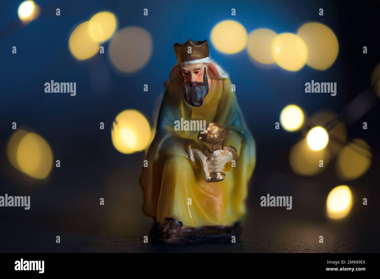 A small Christmas porcelain figure of a king on the background of ...