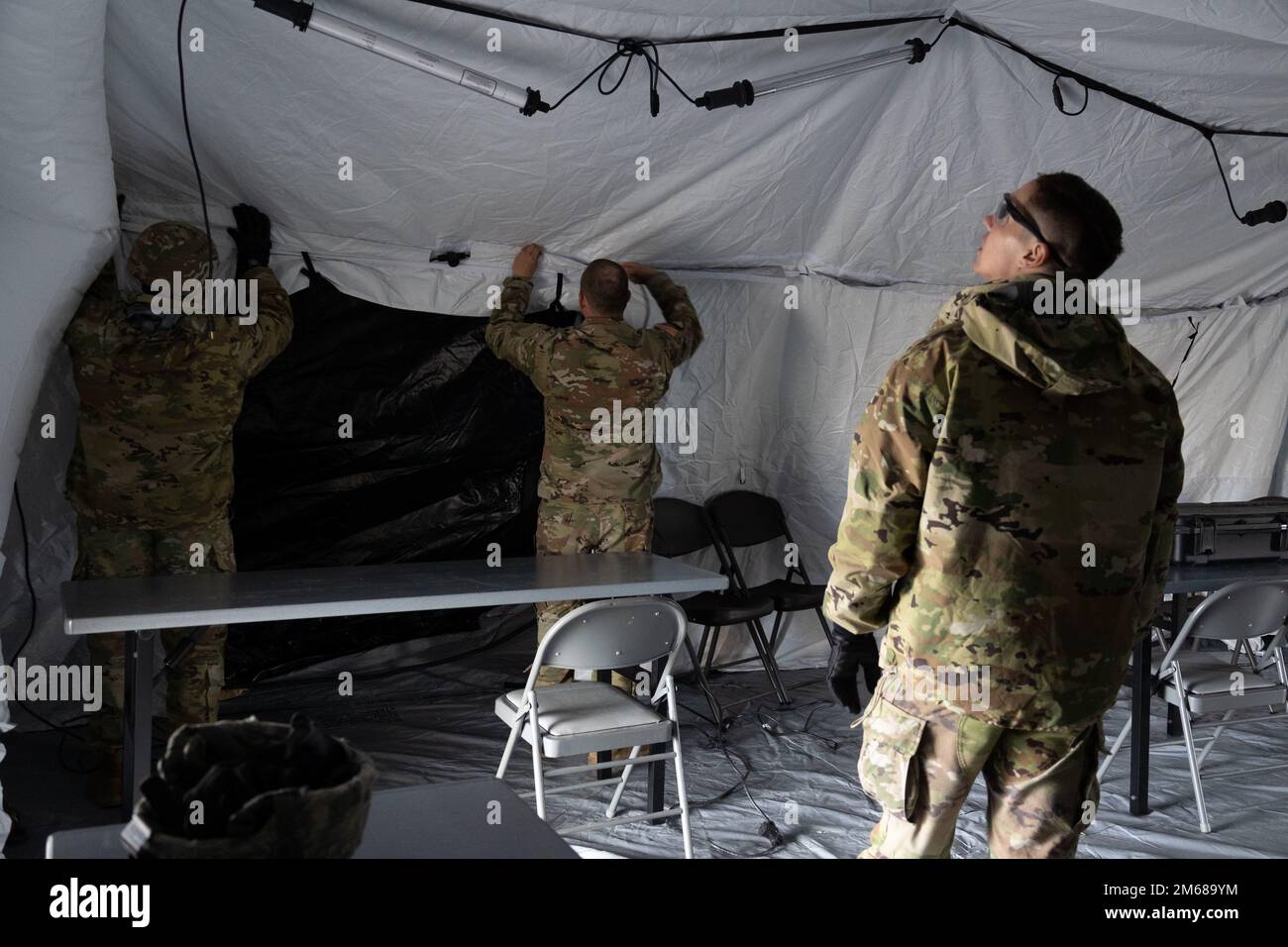 Soldiers of the 1st Theater Sustainment Command set up lighting inside ...
