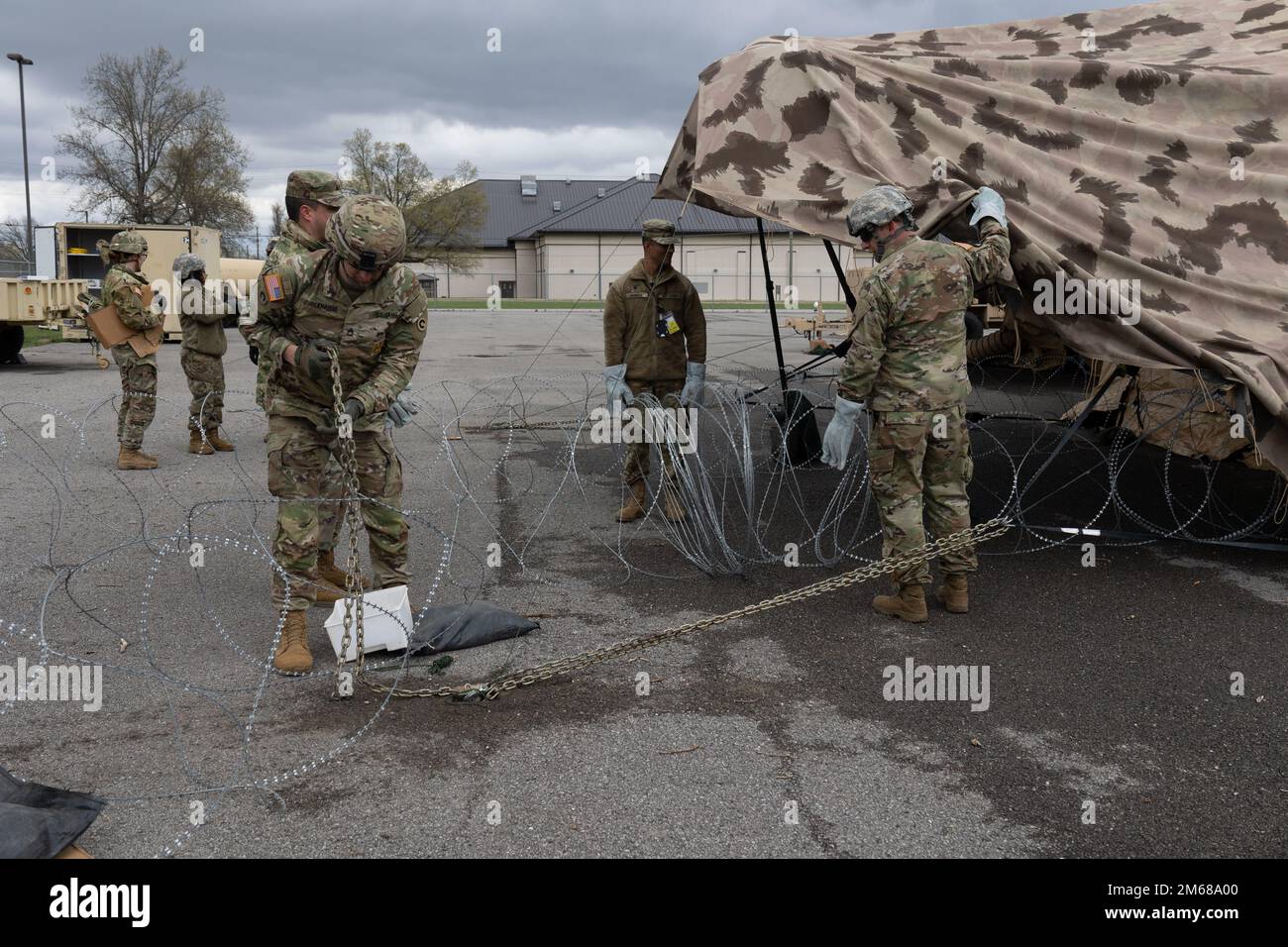 Soldiers of the 1st Theater Sustainment Command lay concertina wire ...