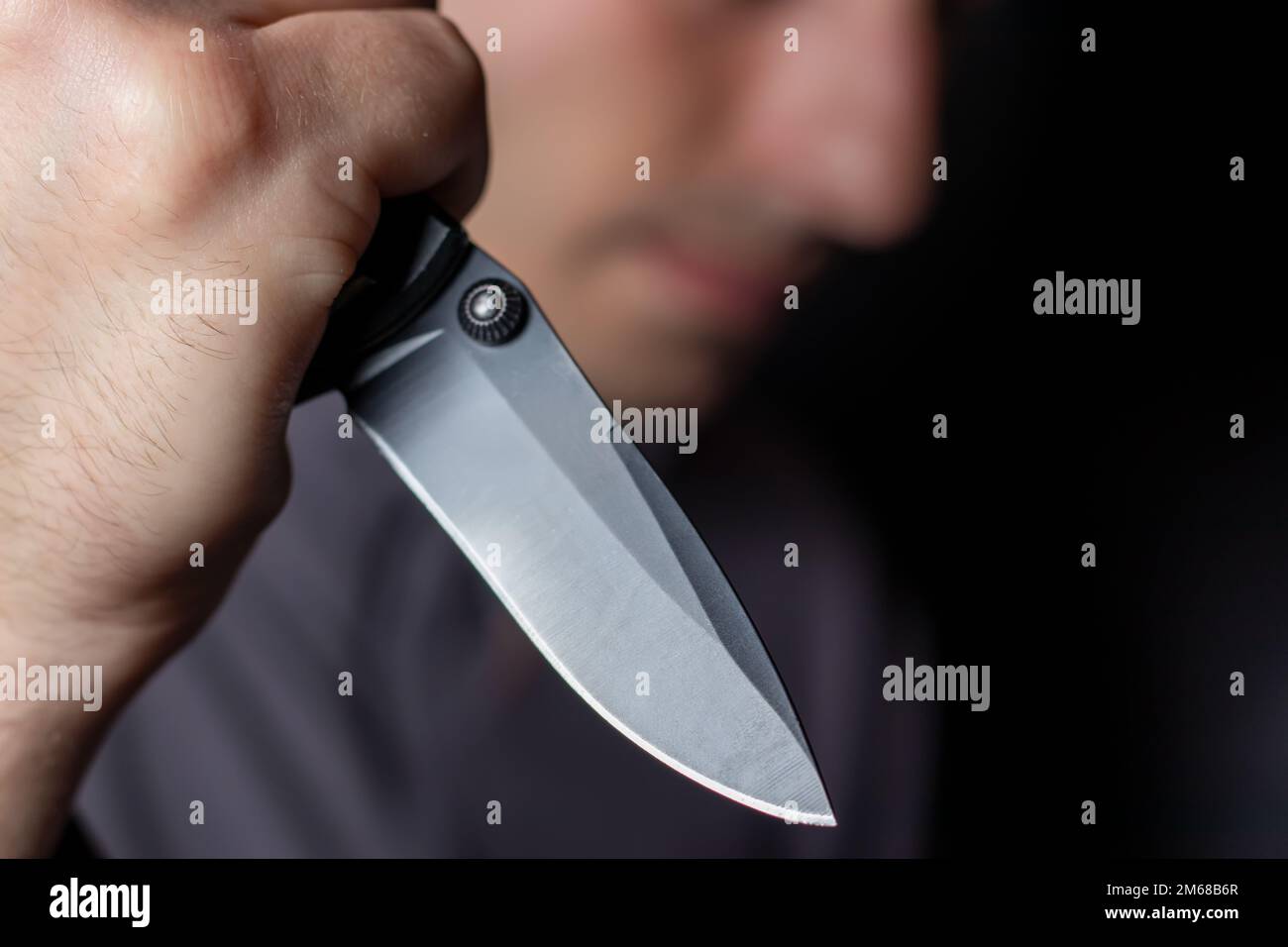 Knife in the hand of a man. Threat with knife. Man attack with knife ...