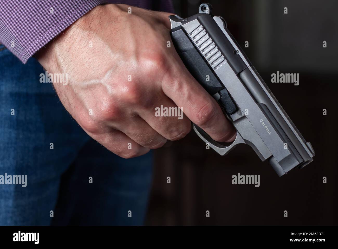 Gun control concept. Armed man holds pistol in hand Stock Photo - Alamy