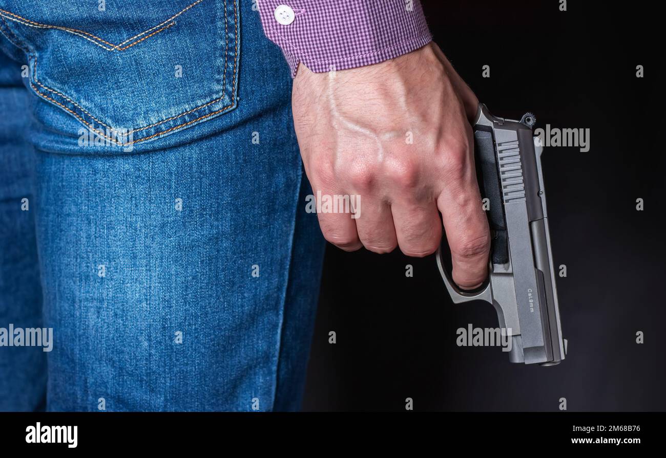 Gun control concept. Armed man holds pistol in hand Stock Photo - Alamy
