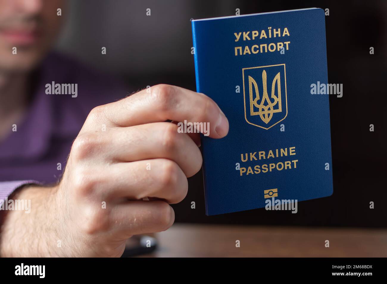 New ukrainian blue biometric passport with identification chip in hands ...
