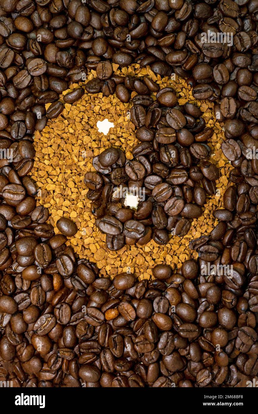 Ying and Yang coffee beans verses granulated coffee Stock Photo - Alamy