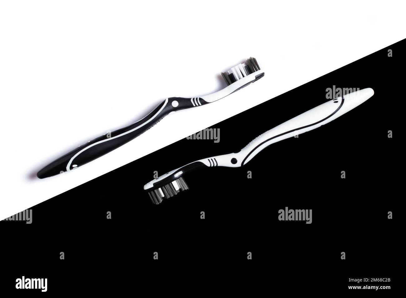 Two toothbrushes on a black and white background. The concept of oral ...