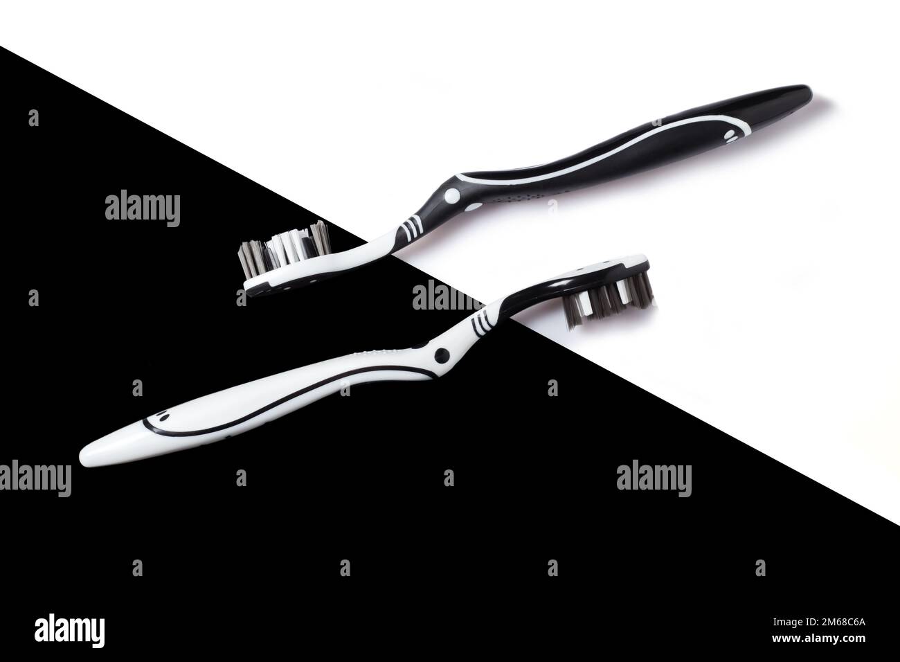 Two toothbrushes on a black and white background. The concept of oral ...
