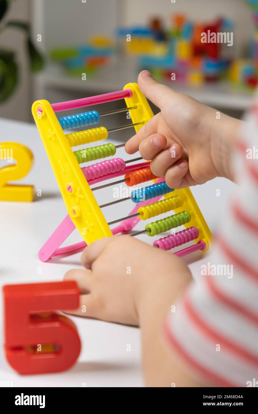 A small child learns to count on abacus, mathematics, arithmetic for ...