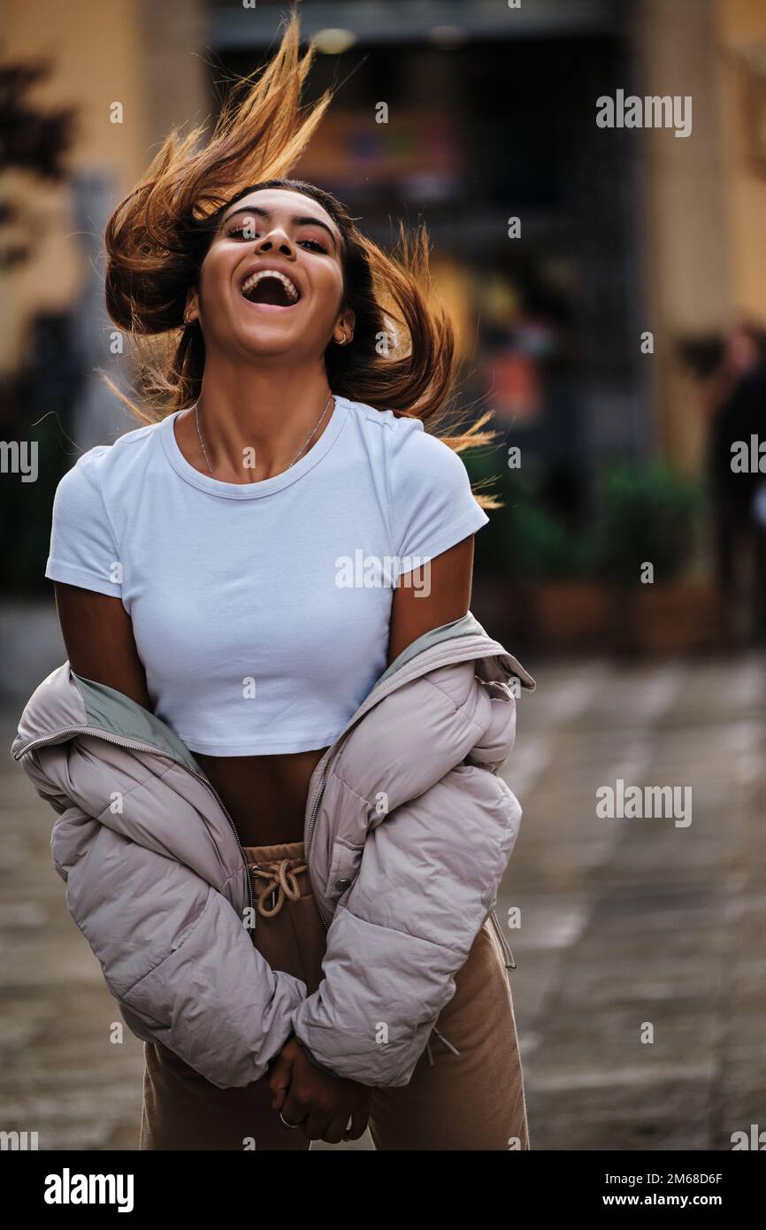 Happy Moroccan woman laughing while standing on the street Stock Photo ...