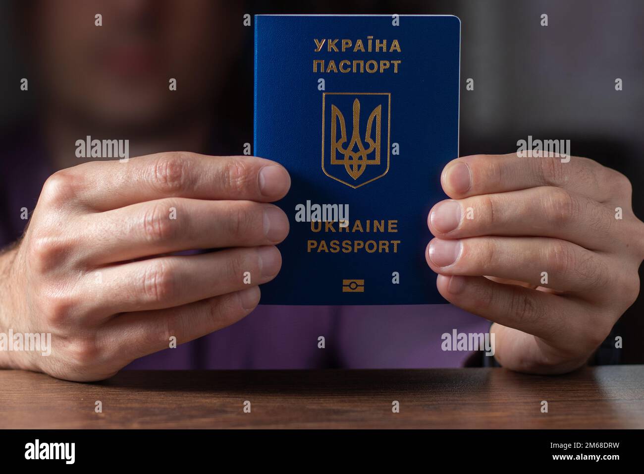New ukrainian blue biometric passport with identification chip in hands ...