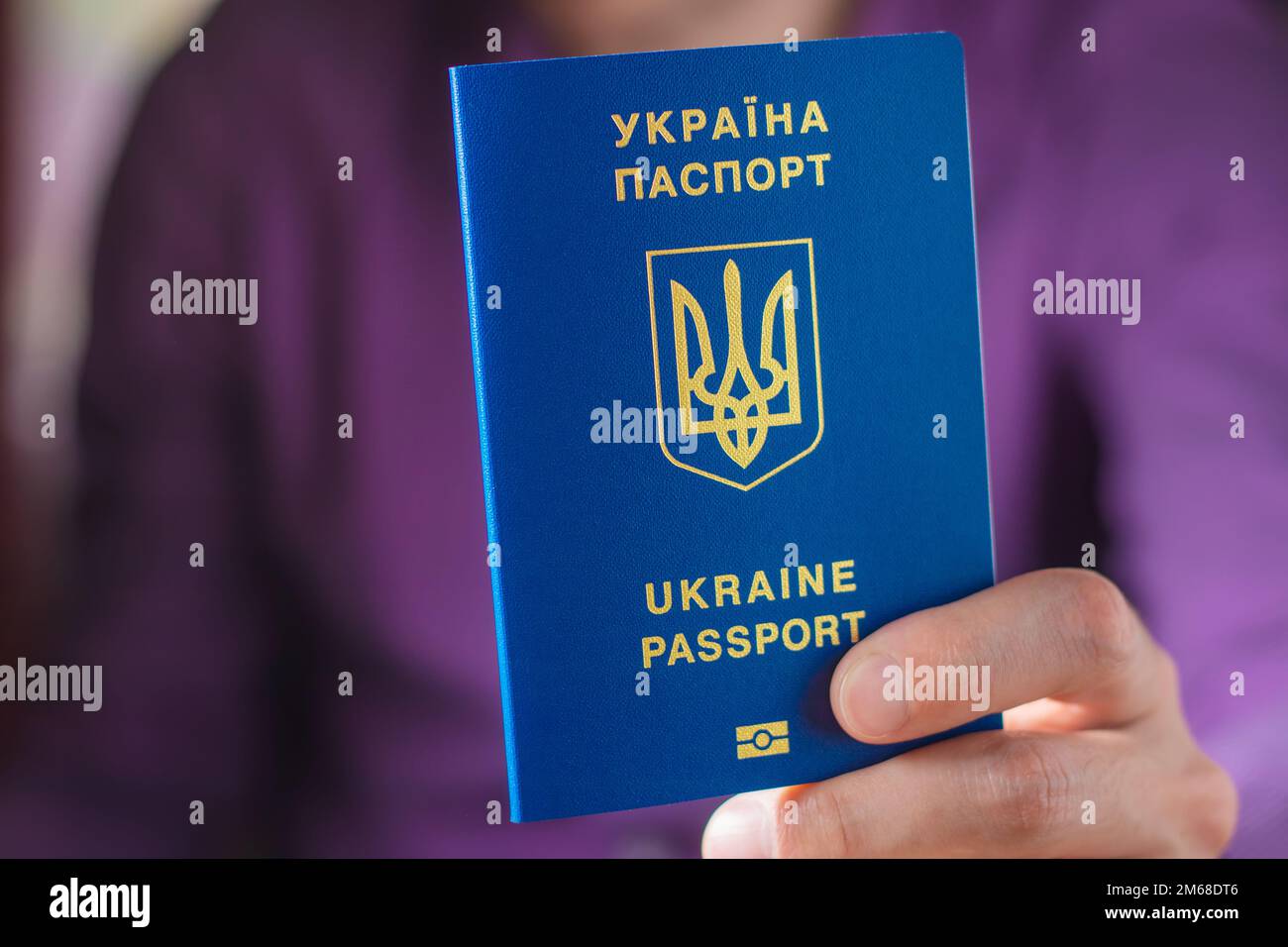 New ukrainian blue biometric passport with identification chip in hands ...