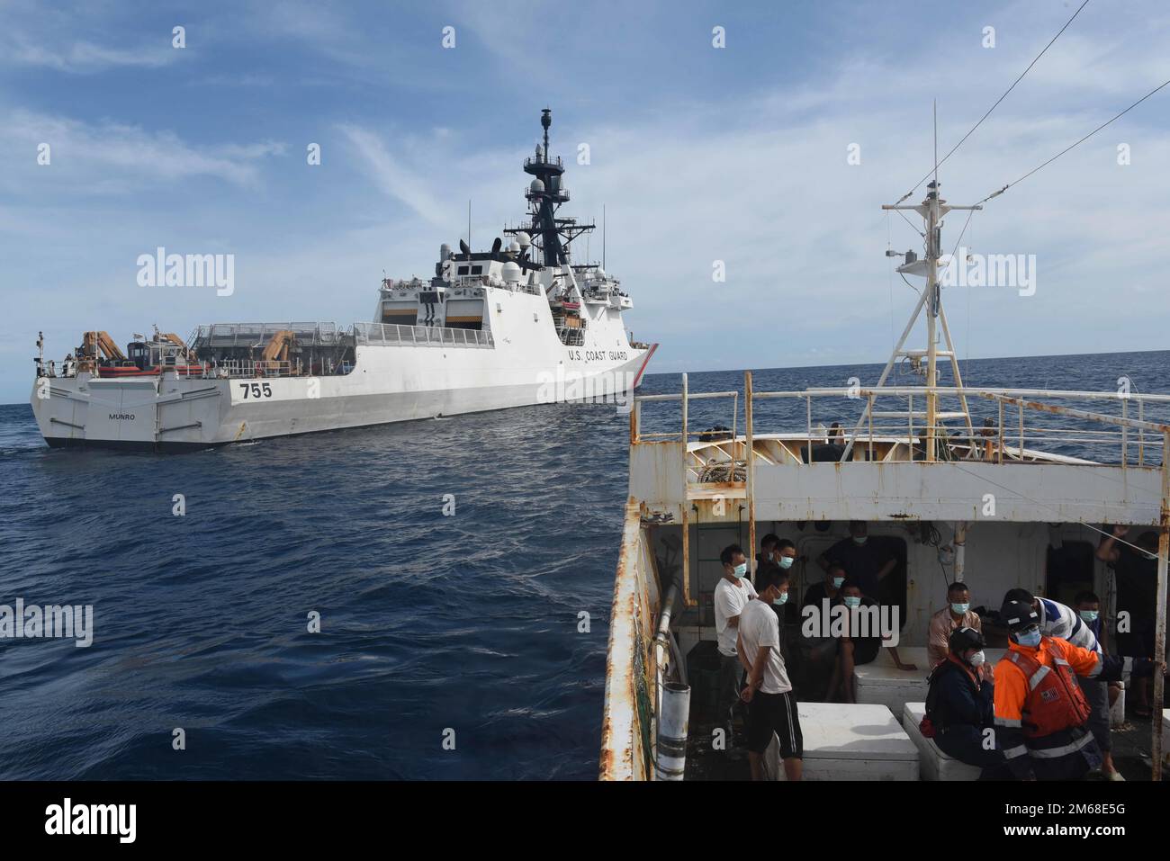 Fijian law enforcement officers work with a Coast Guard boarding team ...