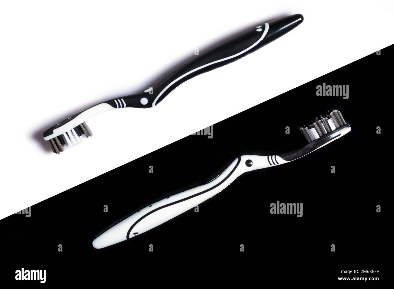 Two toothbrushes on a black and white background. The concept of oral ...