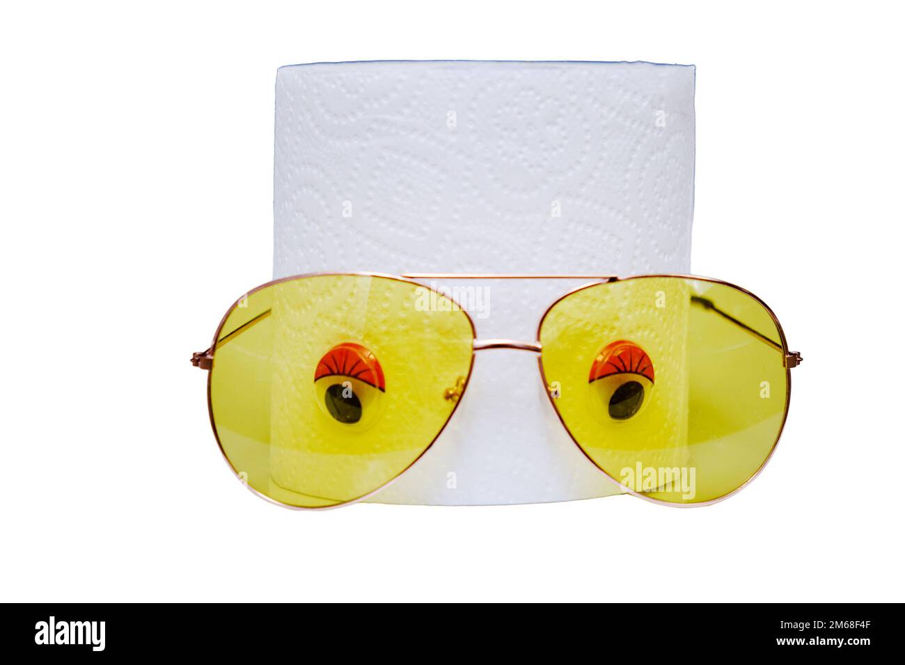 Sanitary paper with eyes on the toilet lid, close-up, isolated on a ...